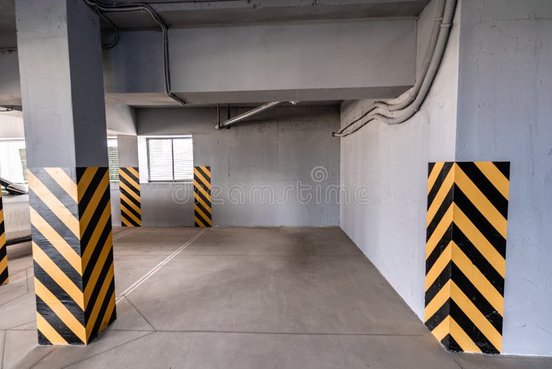 An Empty Underground Garage, Yellow-black Striped Posts, Gray Walls ...