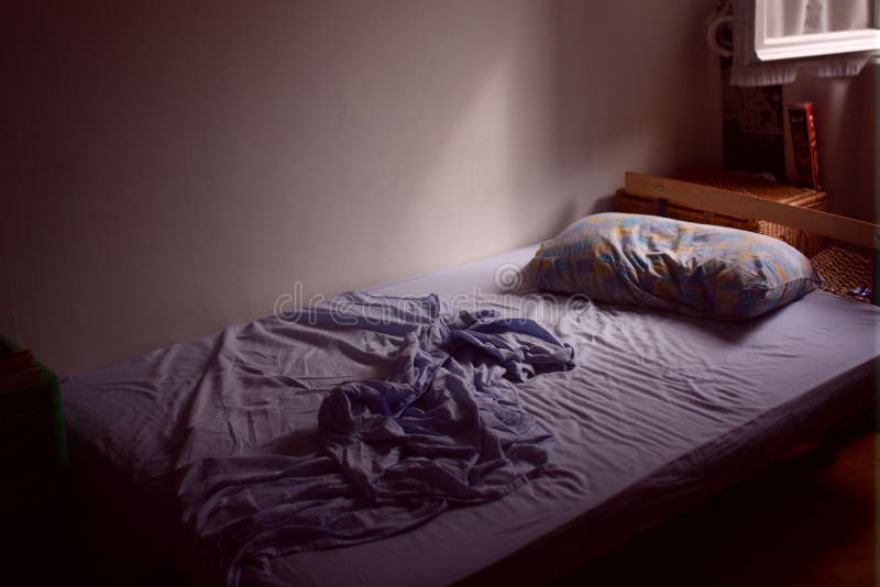 Empty Unmade Bed in a Room with the Dim Morning Light. Stock Photo ...