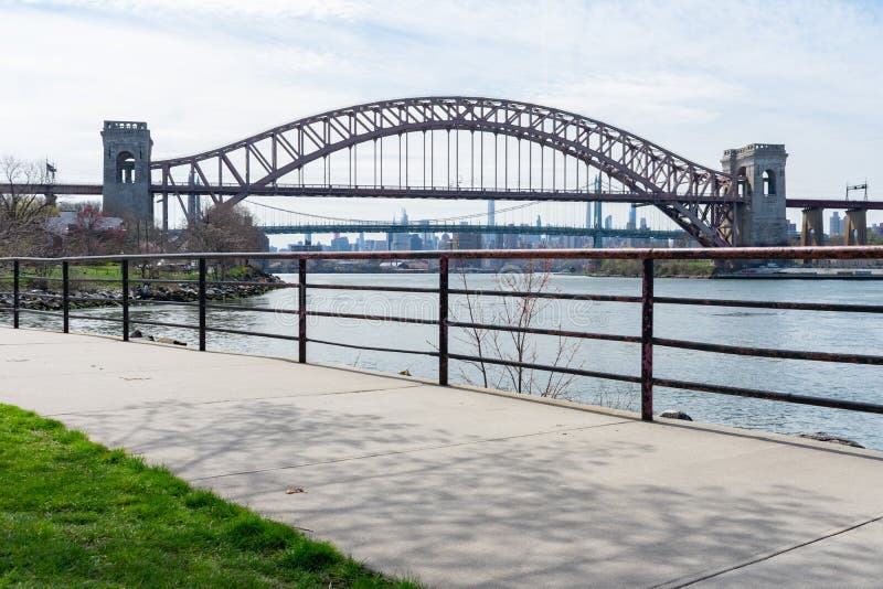 Walkway Along the East River with the Hell Gate Bridge in the ...