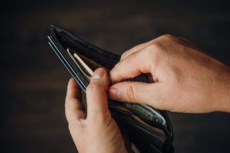 An Empty Wallet with a Small Amount of Money in the Hands of a Working ...