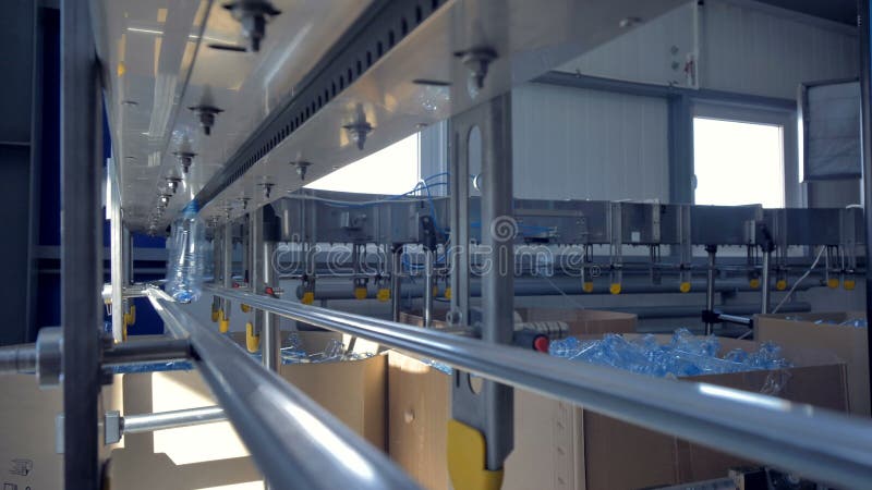 Empty Water Bottles Transferred through a Long Guide Rail in Fast ...