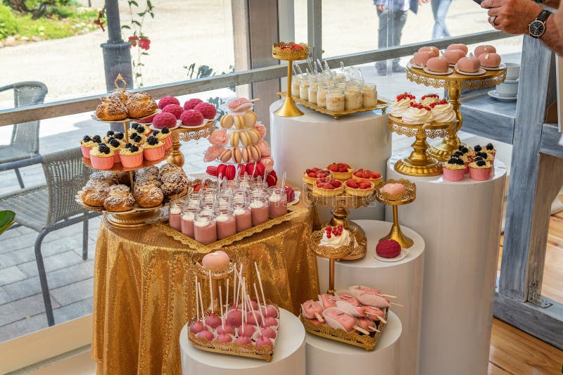 Empty Wedding Reception Hall with Dessert Table Decorated with Pink and ...
