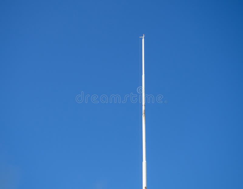 Empty White Flagpole Against the Blue Sky. Lowered Flag Stock Photo ...
