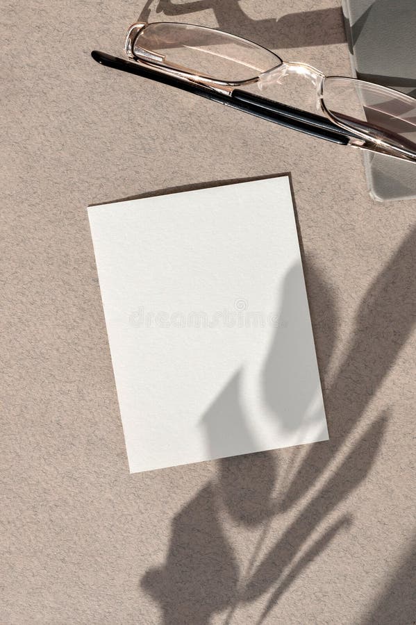 Empty White Paper Sheet Mockup, Glasses, Notepad on Light Brown Table ...