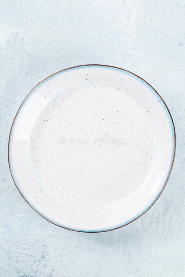 An Empty White Plate with a Blue Rim, Top Shot on a Slate Background ...