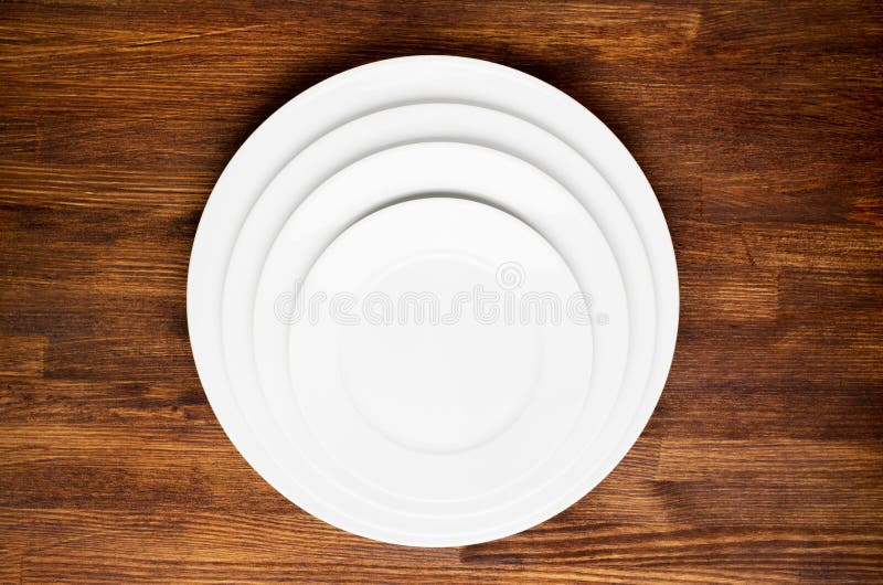 Empty White Plates on Wooden Table Stock Photo - Image of overhead ...