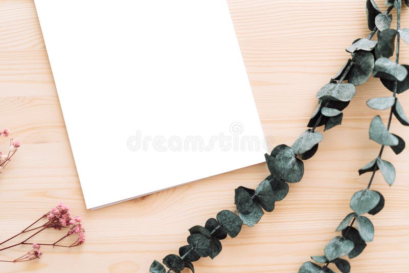 Empty White Sheets with Dried Flowers on Wooden Table Stock Photo ...