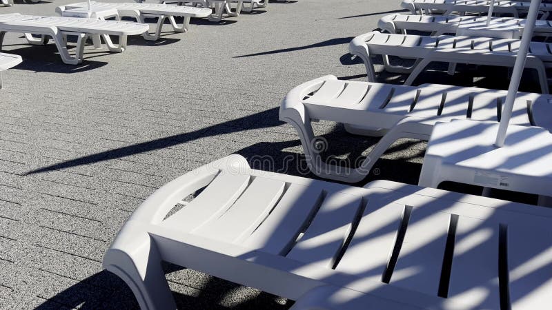 Empty Sun Loungers on Sunny Poolside Patio with Shadows Stock Footage ...