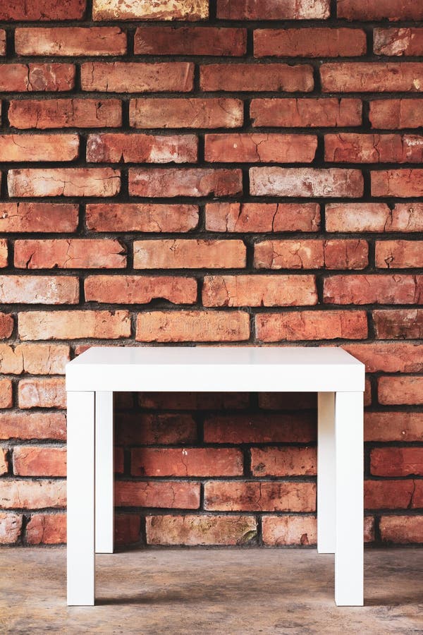 An Empty White Table Against a Brick Wall. Stock Photo - Image of ...