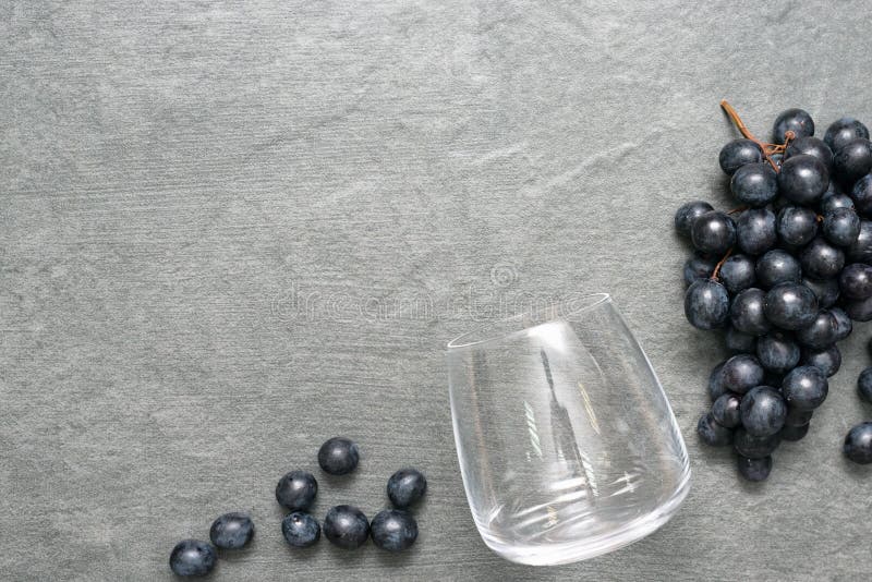 Empty Wine Glass and Black Grapes Stock Photo - Image of organic, gray ...