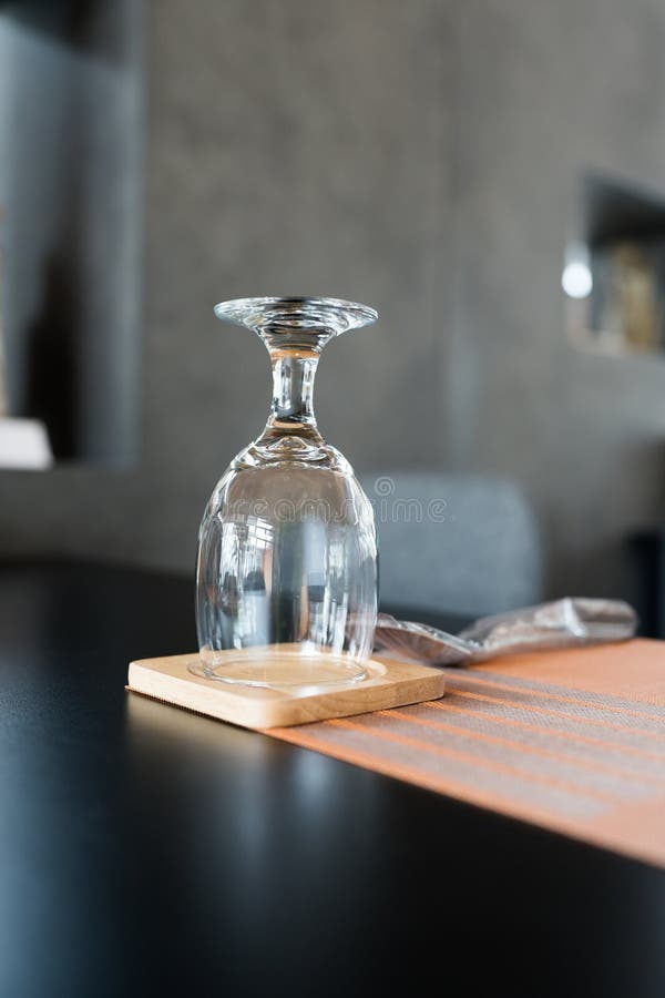 An Empty Wine Glass is Placed Upside Down on the Dining Table Stock ...