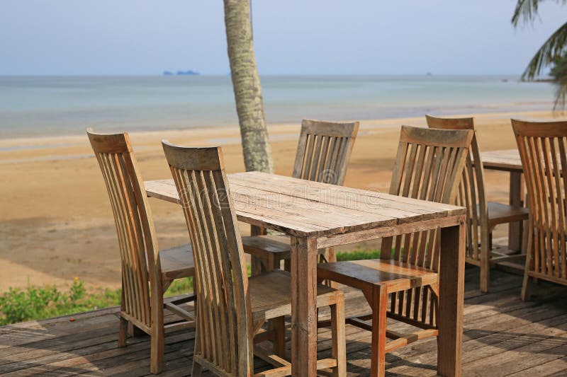 Empty Wood Table and Chairs at Restaurants Near the Beach Stock Photo ...