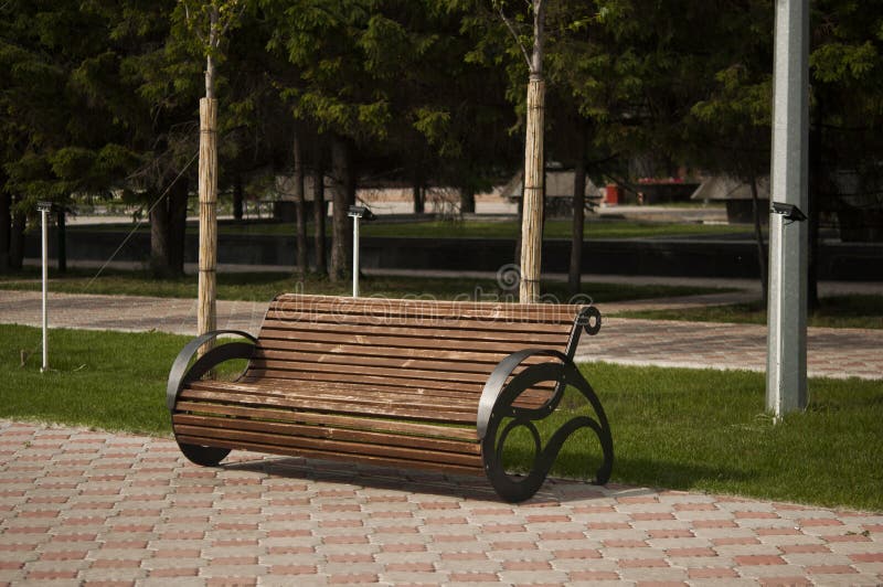 Empty Wooden Bench in the Park beside the Grass and Path Stock Image ...
