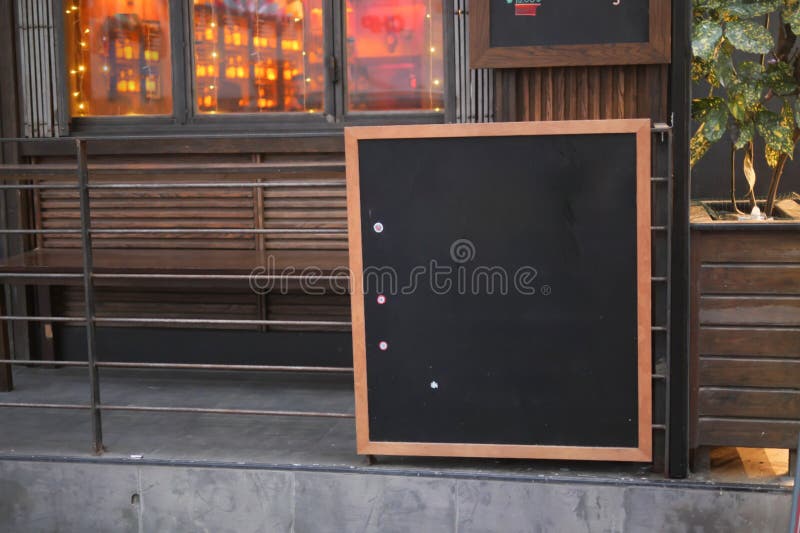 Empty Wooden Blackboard Mockup Standing Outdoors in Front of Cafe Stock ...
