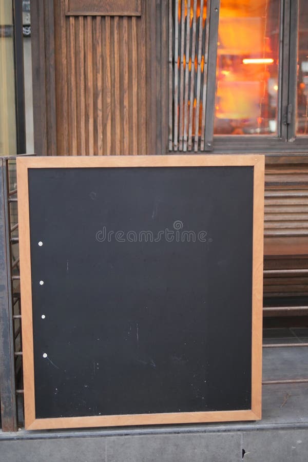 Empty Wooden Blackboard Mockup Standing Outdoors in Front of Cafe Stock ...