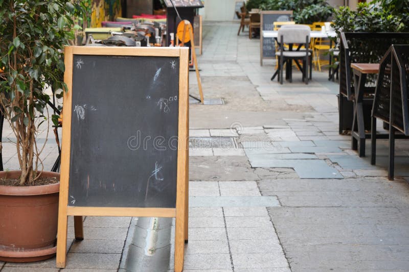 Empty Wooden Blackboard Mockup Standing Outdoors in Front of Cafe Stock ...