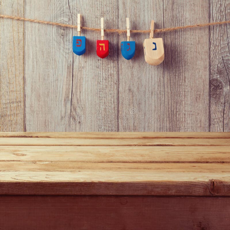 Empty Wooden Deck Table with Hanukkah Dreidel Spinning Top Hanging on ...