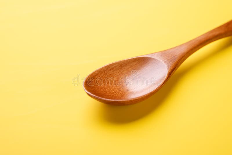 Empty Wooden Spoon on Yellow Background Stock Image - Image of reuse ...
