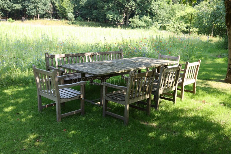 Empty Wooden Table with Bench and Chairs in Garden Stock Photo - Image ...