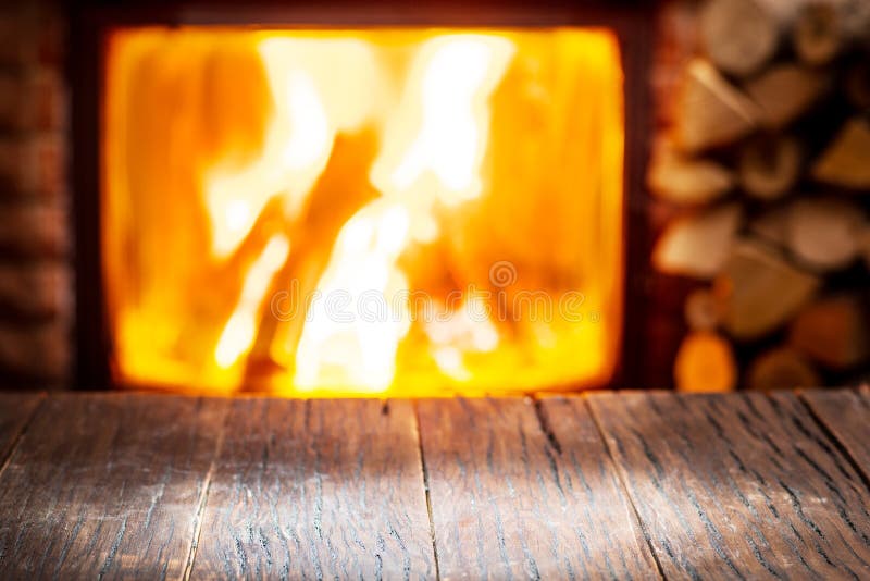 Empty Wooden Table and Fireplace with Warm Fire at the Background Stock ...