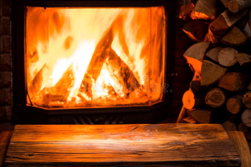 Empty Wooden Table and Fireplace with Warm Fire at the Background Stock ...
