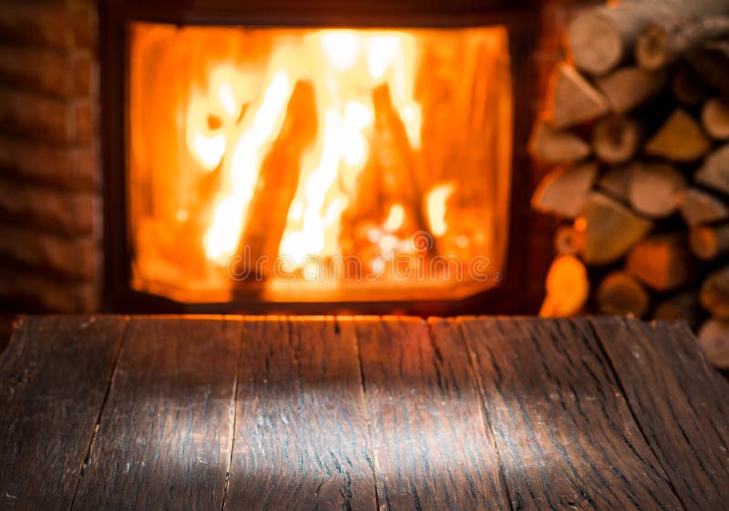 Empty Wooden Table and Fireplace with Warm Fire at the Background Stock ...