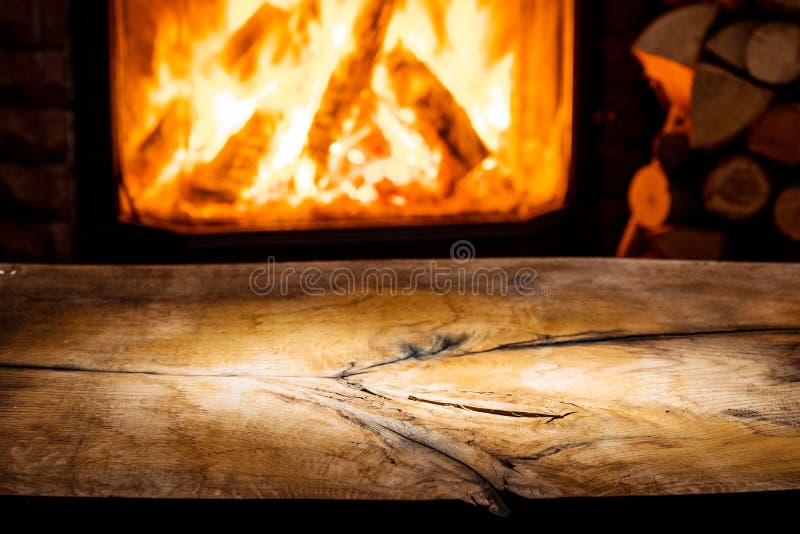 Empty Wooden Table and Fireplace with Warm Fire at the Background Stock ...