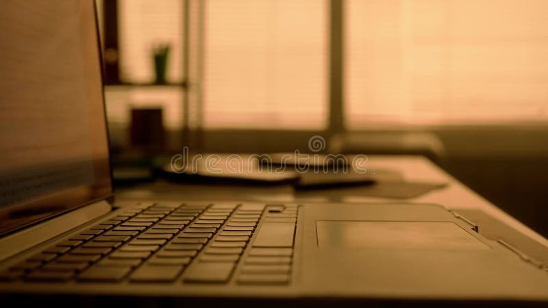 Empty Workplace in a Dark Evening Office. an Open Laptop, Pen and ...