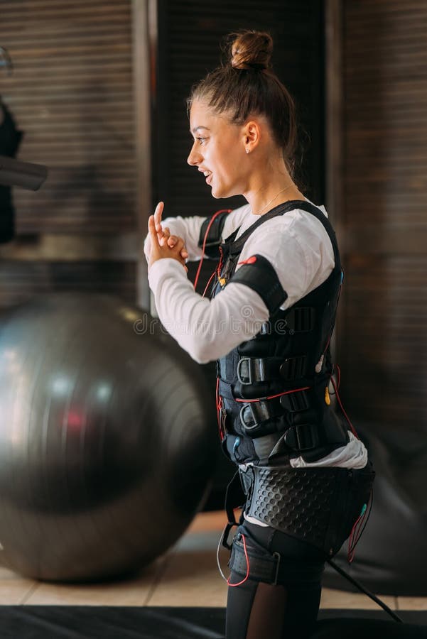 EMS Training. Girl Doing Exercises in a Suit with Cables. Stock Photo ...