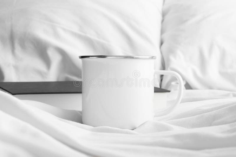 Enamel Mug Mockup with a Book on the Bed Stock Image - Image of bedding ...