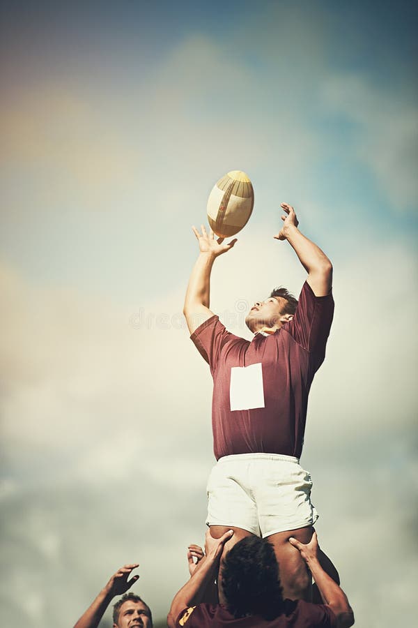 On the End of a Long Throw. a Young Rugby Player Catching the Ball ...