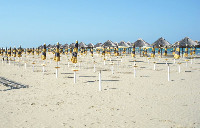 Open and Closed Beach Parasol on the Beach Stock Photo - Image of ...