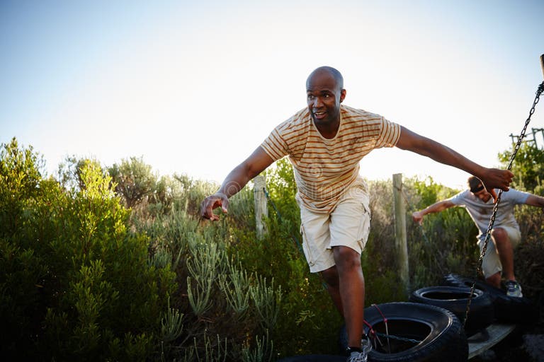 The End is in Sight...a Group of Men Going through an Obstacle Course ...