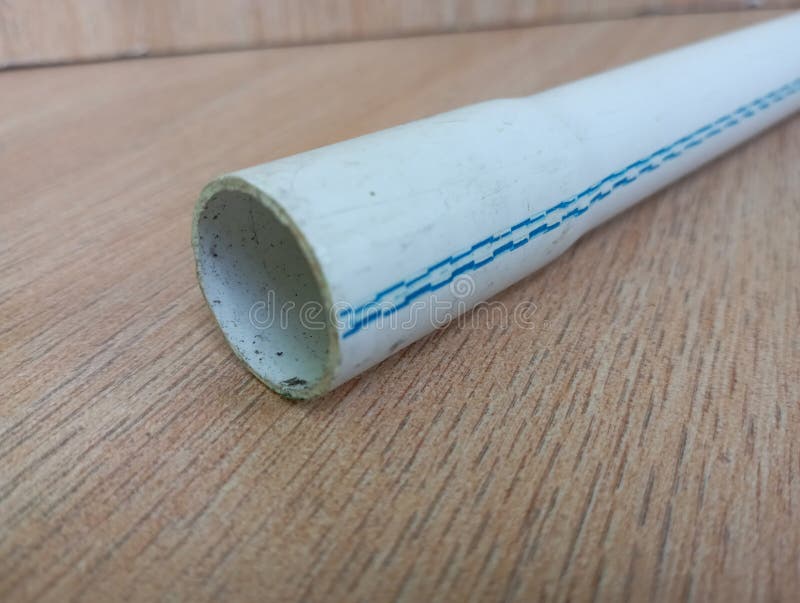 The End of a White Plastic Pipe Circle on a Ceramic Floor with a Wood ...