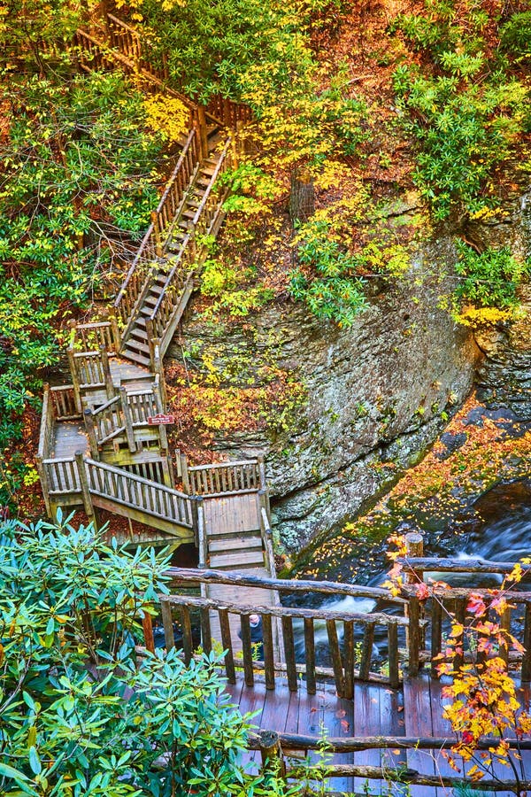 Endless Boardwalk Stairs Across River and Up Cliffs Surrounded by Fall ...