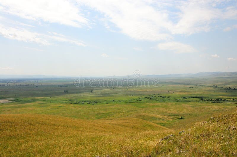 Endless Hilly Steppe with Low, Yellowed Grass Under a Cloudy Summer Sky ...