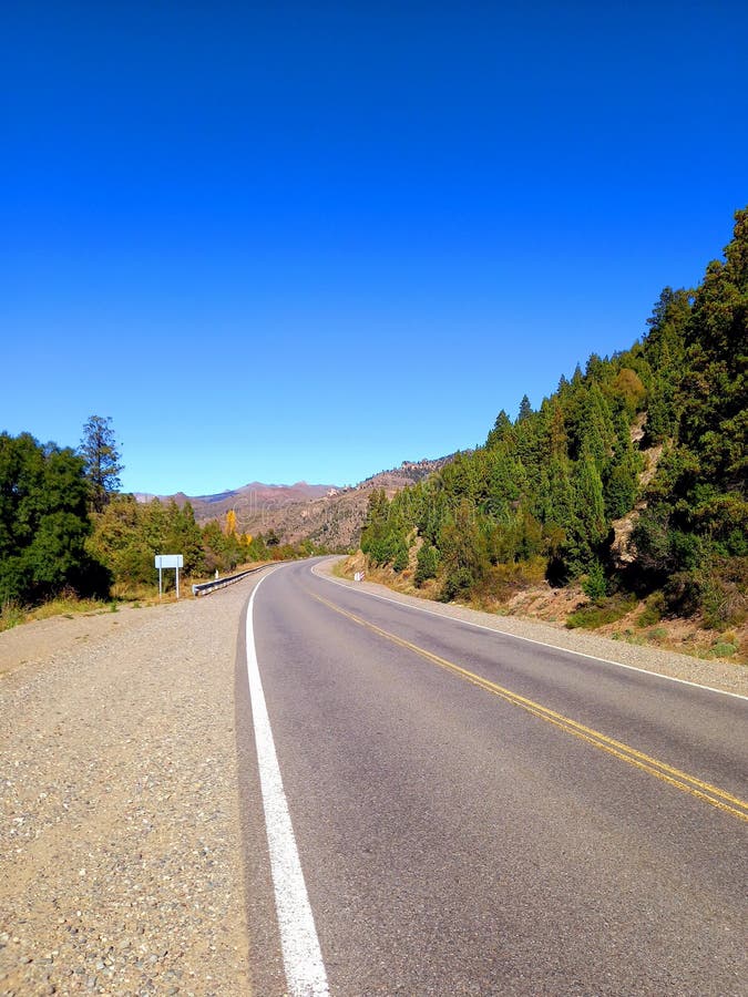 Endless Road with Curve in Mountainous Landscape and Blue Sky. Driving ...