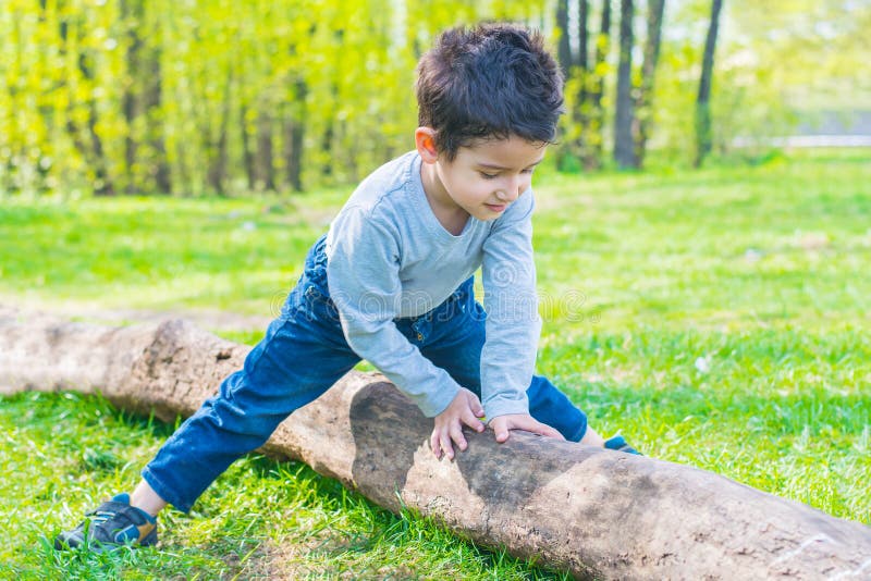 Energetic Boy Playing in Nature Stock Image - Image of jump, occupation ...
