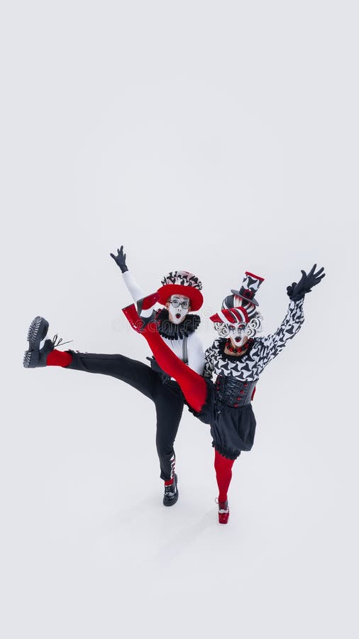 Energetic Circus Duo Executing Synchronized High Kicks, Radiating Joy ...