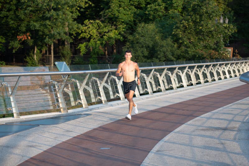 Energetic Man Runner with Muscular Torso Running Stock Photo - Image of ...