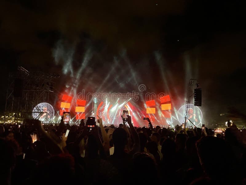 Energetic Nighttime Concert with Crowd and Dramatic Stage Lighting ...