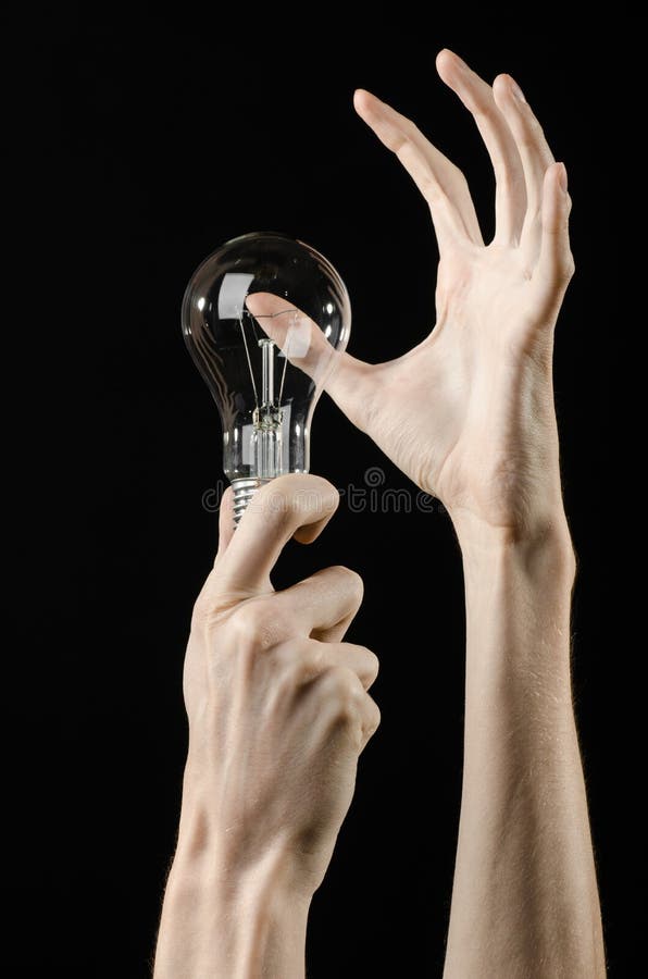Energy Consumption and Energy Saving Topic: Human Hand Holding a Light ...