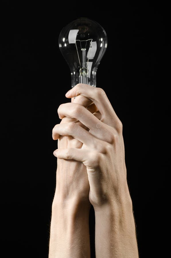 Energy Consumption and Energy Saving Topic: Human Hand Holding a Light ...