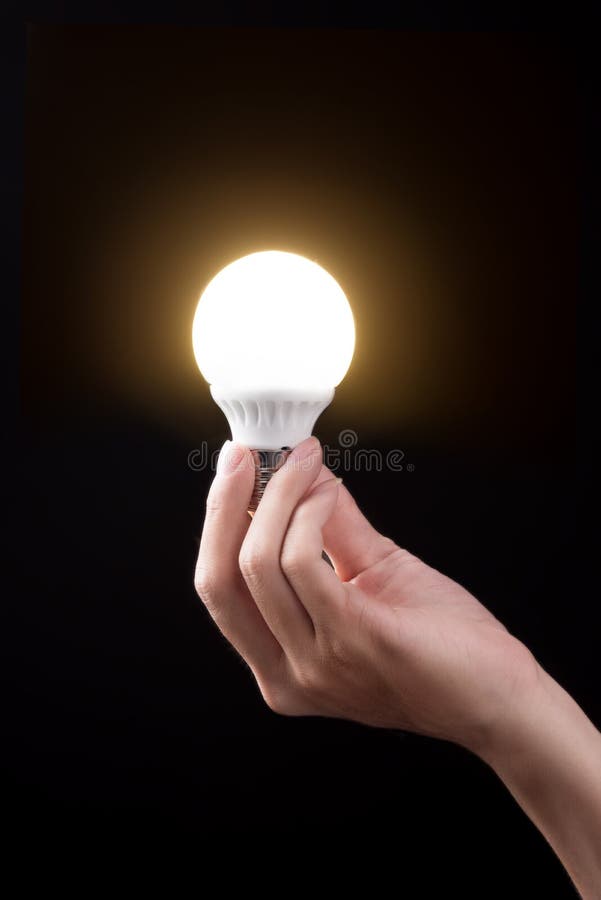 Energy Consumption and Energy Saving Topic: Human Hand Holding a Stock ...