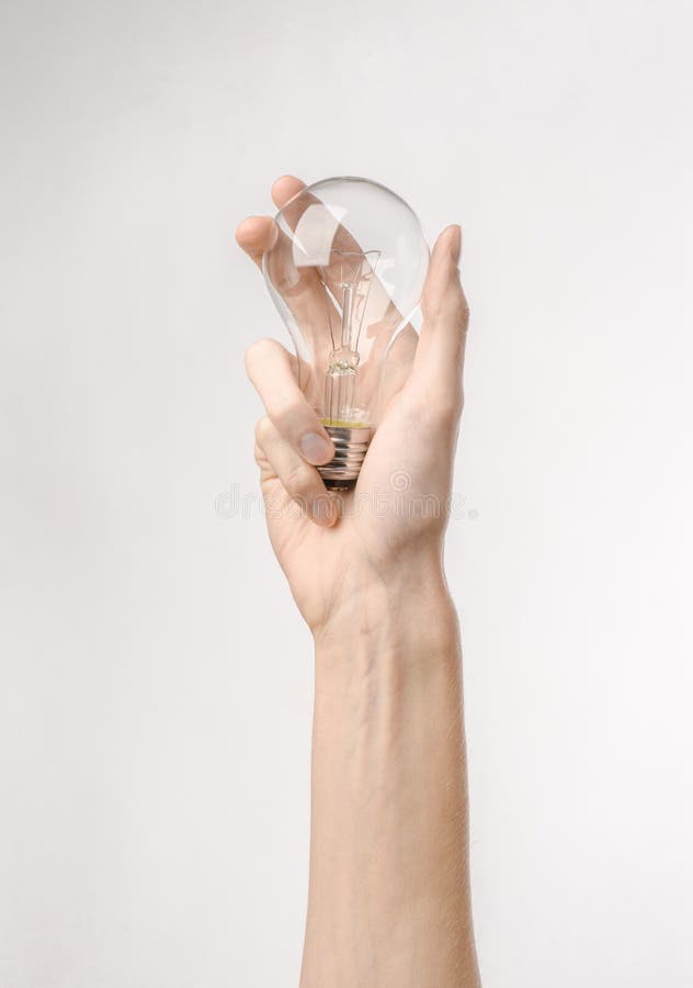 Energy Consumption and Energy Saving Topic: Human Hand Holding a Light ...