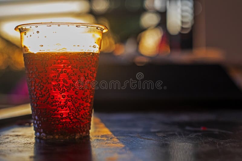 Energy Drink in a Plastic Cup Against the Sun. Horizontal Stock Photo ...