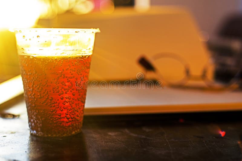 Energy Drink in a Plastic Transparent Cup Against the Sun. Horizontal ...