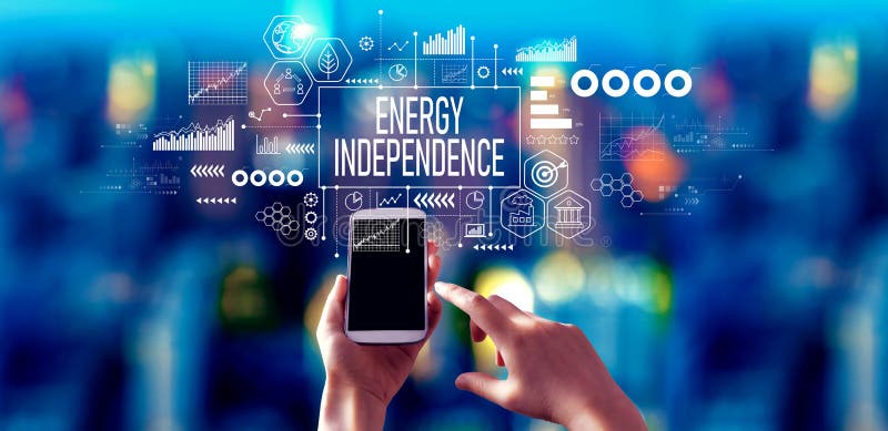 Energy Independence Concept with Person Using a Smartphone at Night ... Energy Independence Concept with Person Using a Smartphone at Night ...