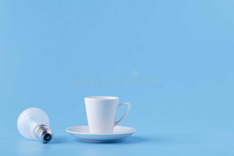 Energy for Long Day, Coffee Cup on Blue with Light Bulb Stock Photo ...