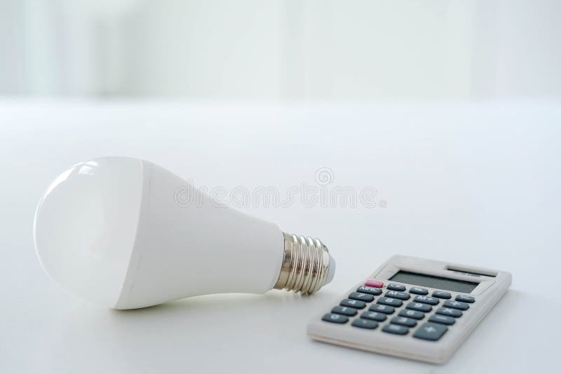 Energy Saving Concept. Calculator with Light Bulb Stock Image - Image ...